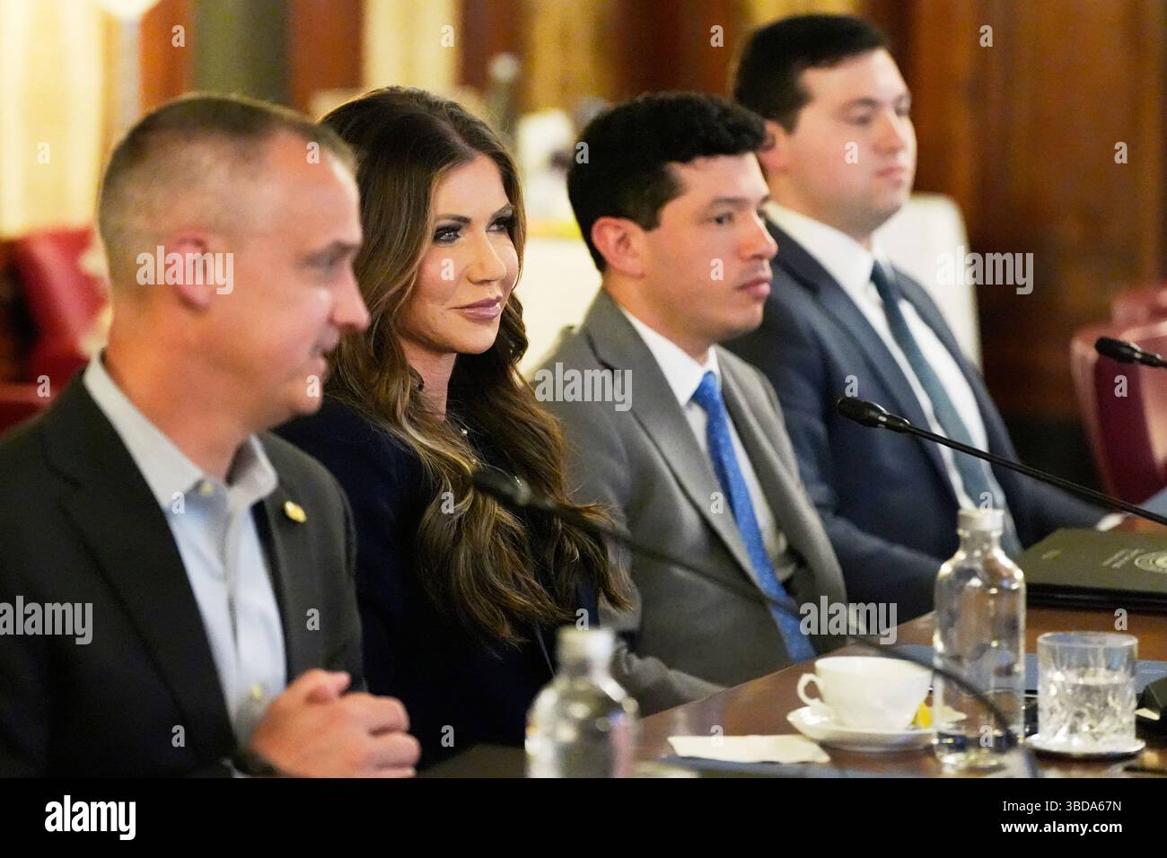 U.S. Homeland Security Secretary Kristi Noem, second from left, attends ...