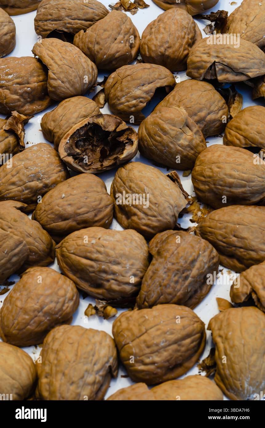 Vertical view of walnut shell halves, one upside down, filling the ...