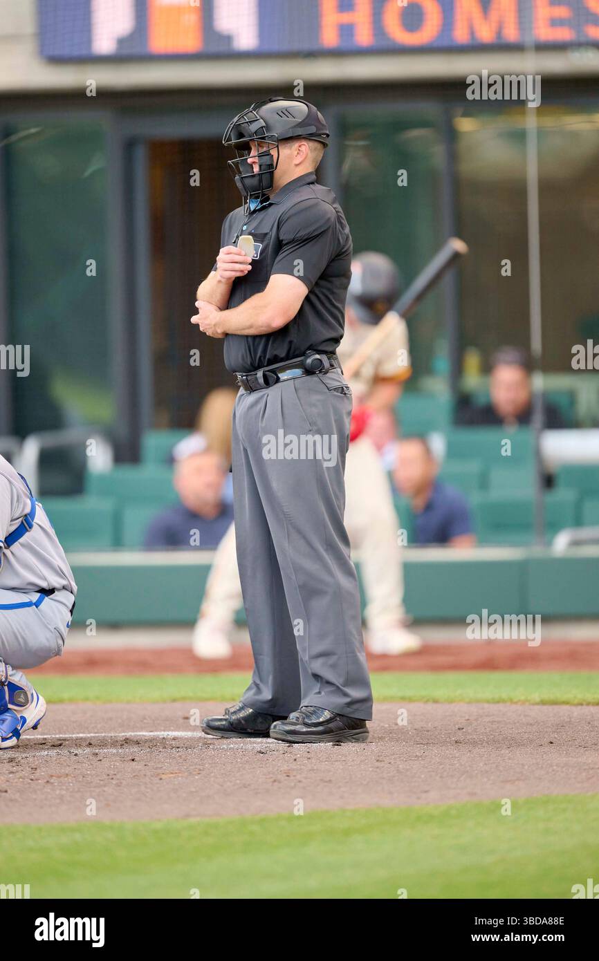 Umpire Tanner Moore handles the calls behind the plate during the game ...