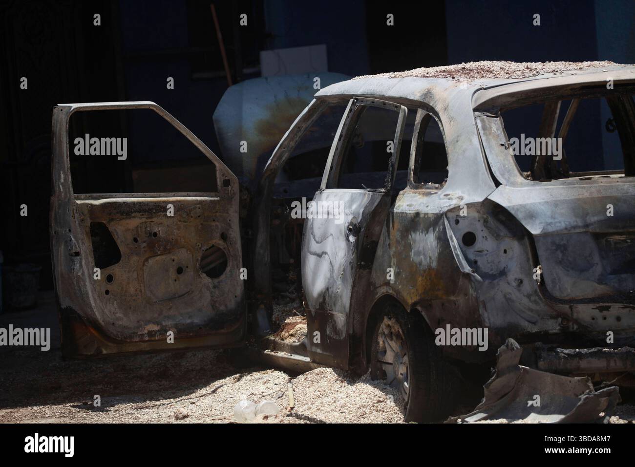 A man looks at a damaged vehicle after Israeli army demolishes ...