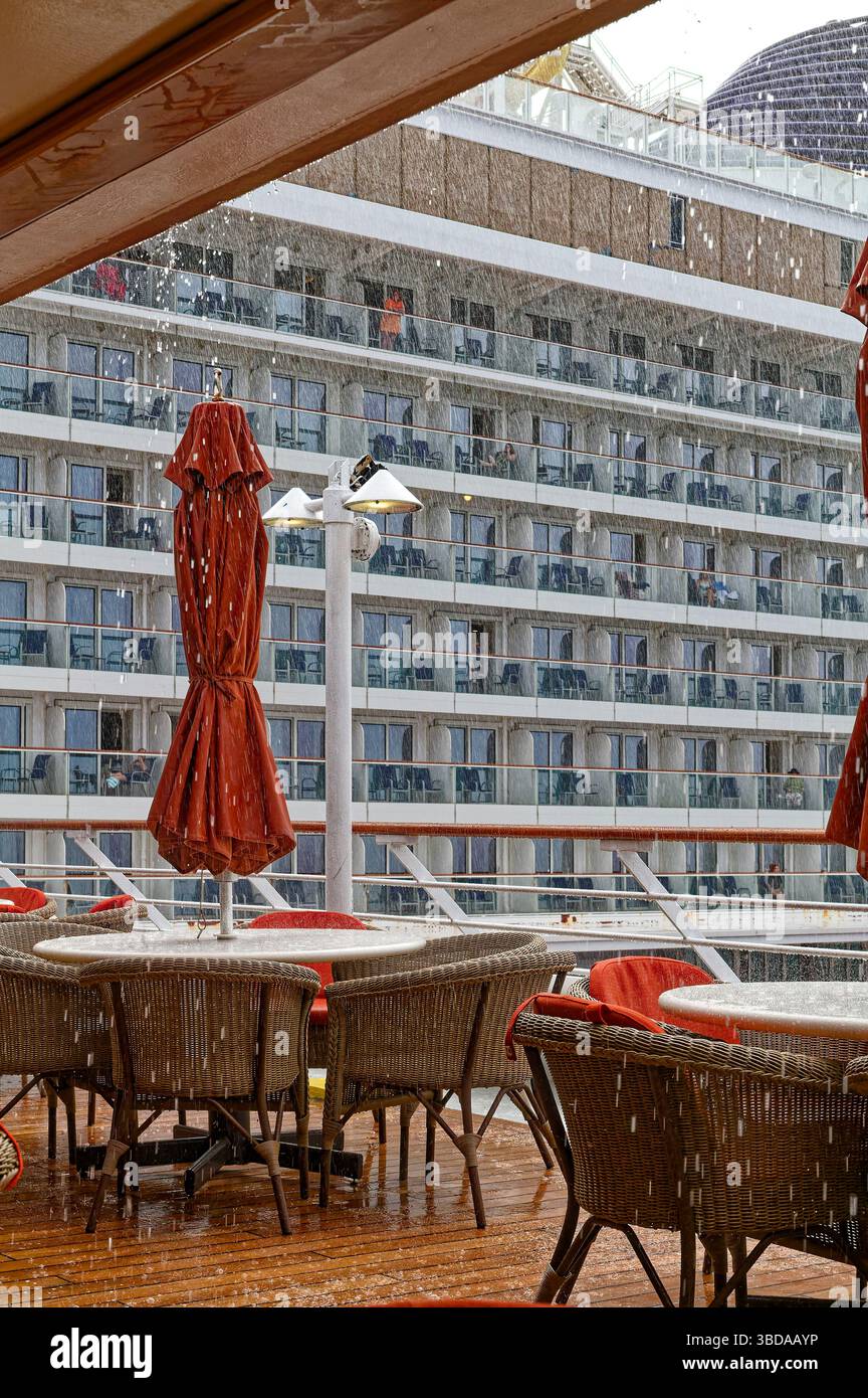 rain, ship's outdoor restaurant, wet, tables, chairs, folded umbrella ...