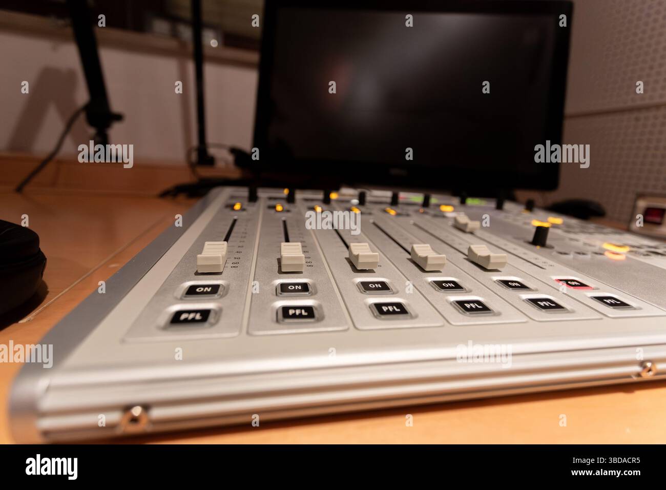A detailed view of an audio mixing console in a studio environment ...