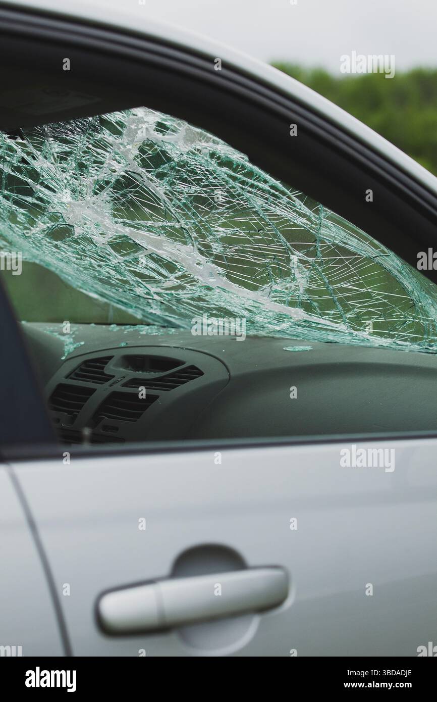 Interior view of car with shattered windshield and scattered glass ...