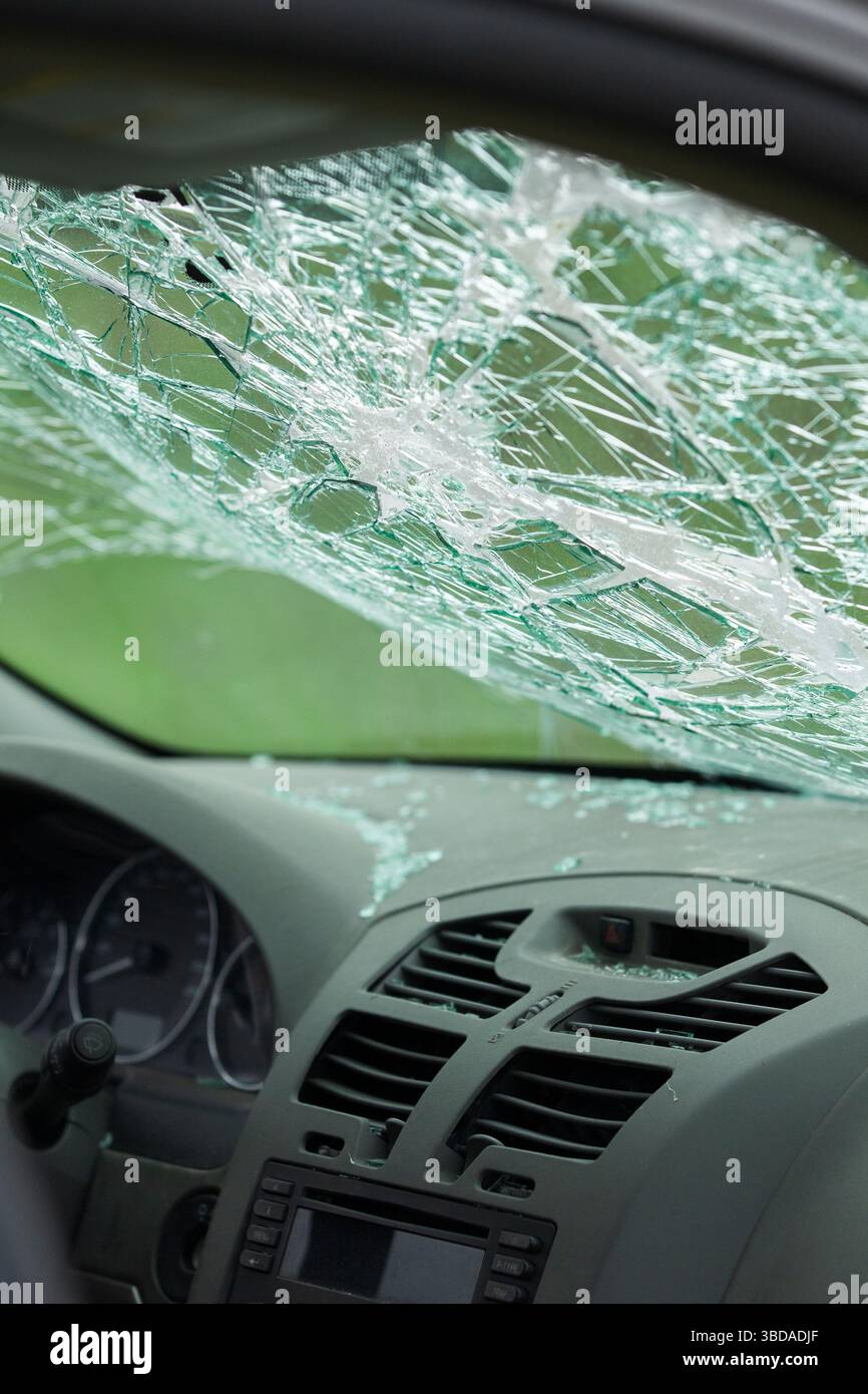 Interior view of car with shattered windshield and scattered glass ...
