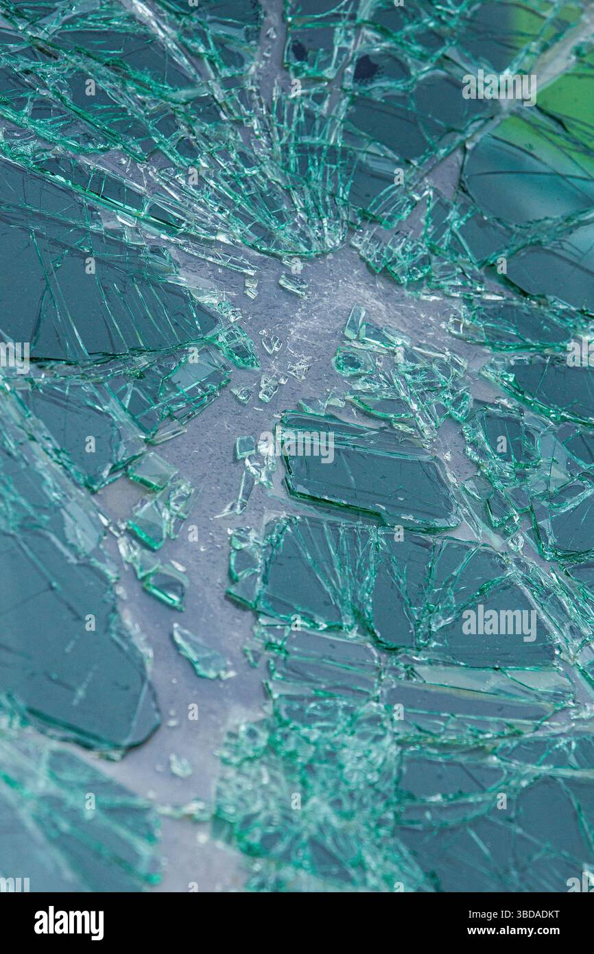 Close-up of shattered green safety glass with intricate cracks. Broken ...