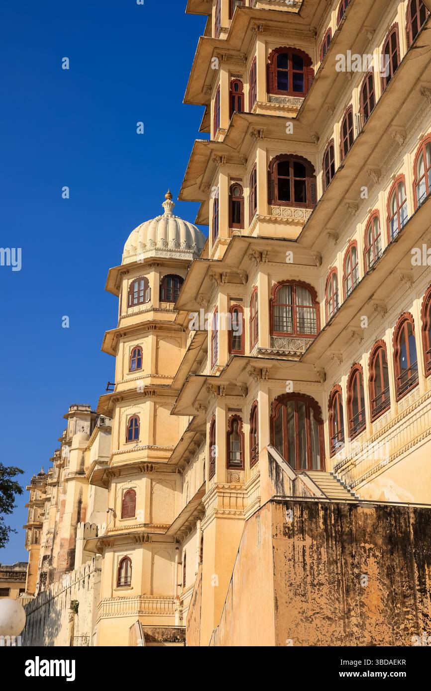 Tall walls of historic City Palace in Udaipur , India reaching blue sky ...