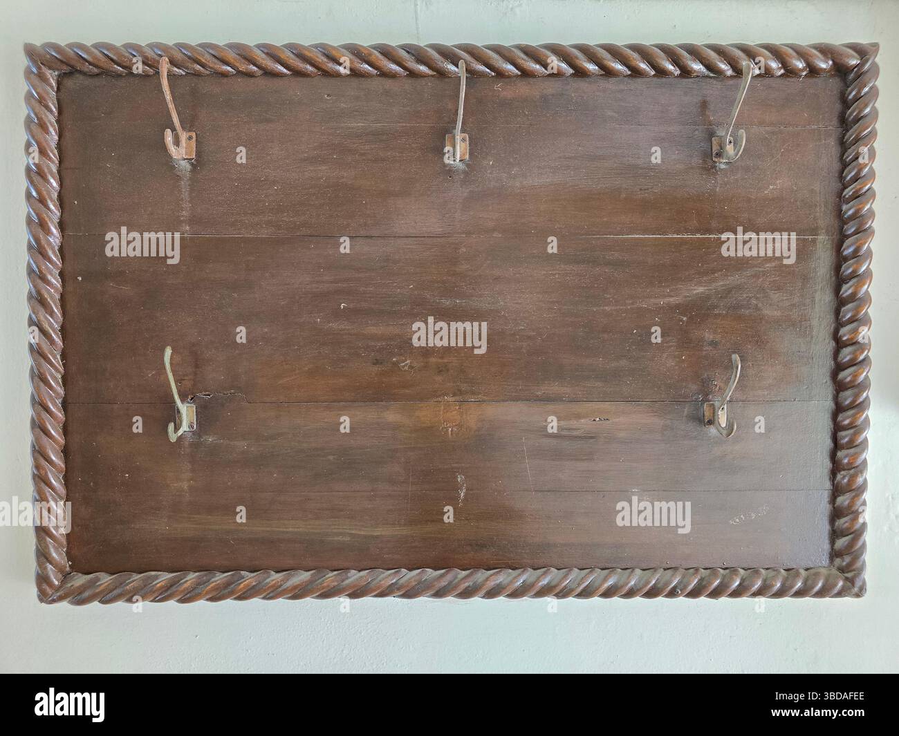 Antique wooden wall hook rack with rope frame Stock Photo - Alamy