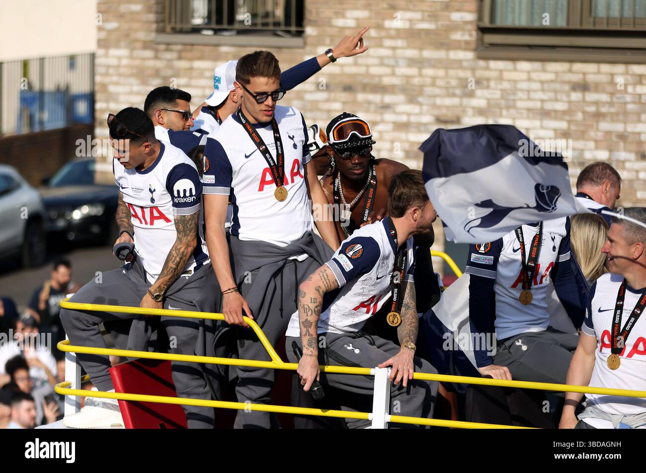 Tottenham Hotspur's Micky van de Ven (centre left) on the open-top team ...