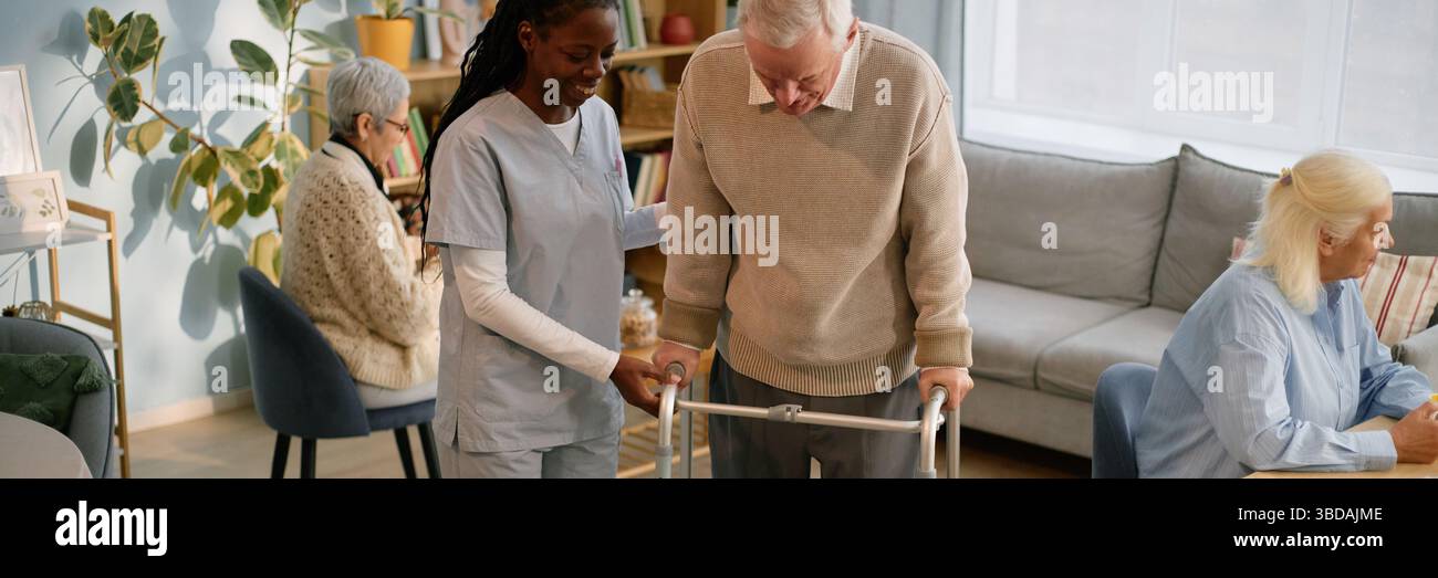 Senior Man Receiving Assistance from Nurse While Walking Stock Photo ...