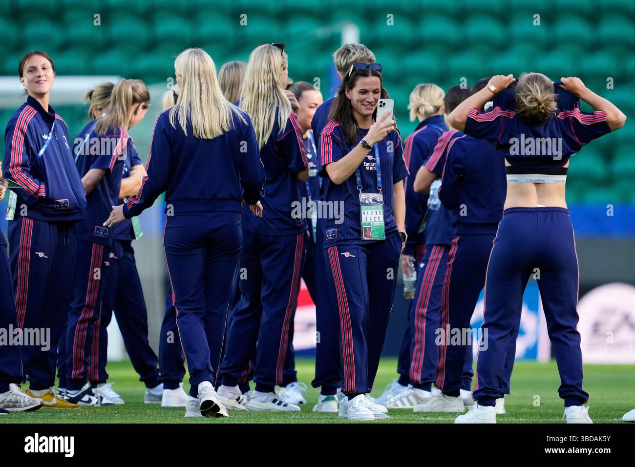 Arsenal's Laia Codina, center, takes photos of a teammate as they ...