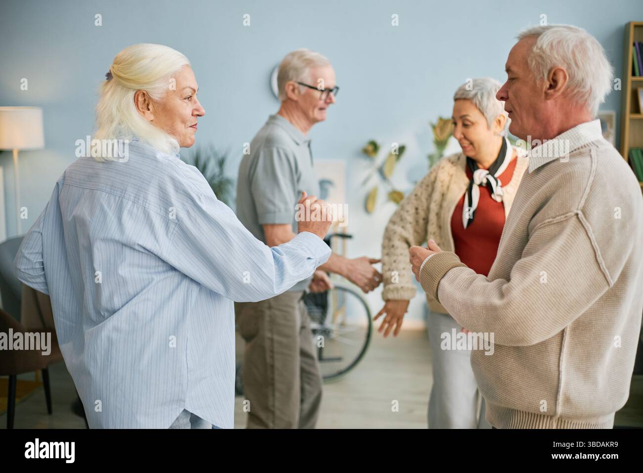 Seniors Having Engaging Conversations in Living Room Stock Photo - Alamy