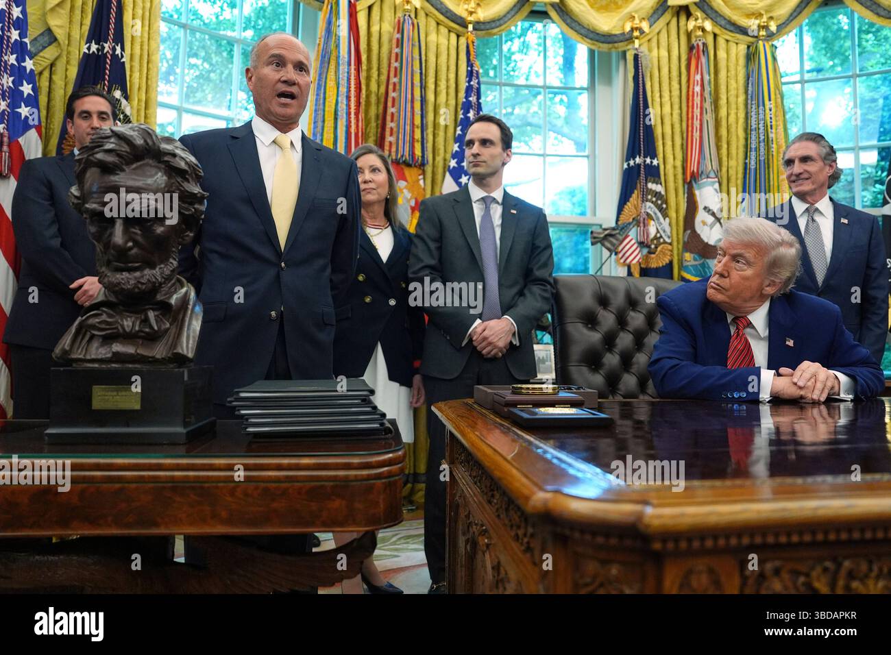 President Donald Trump listens as Joseph Dominguez, president and CEO ...