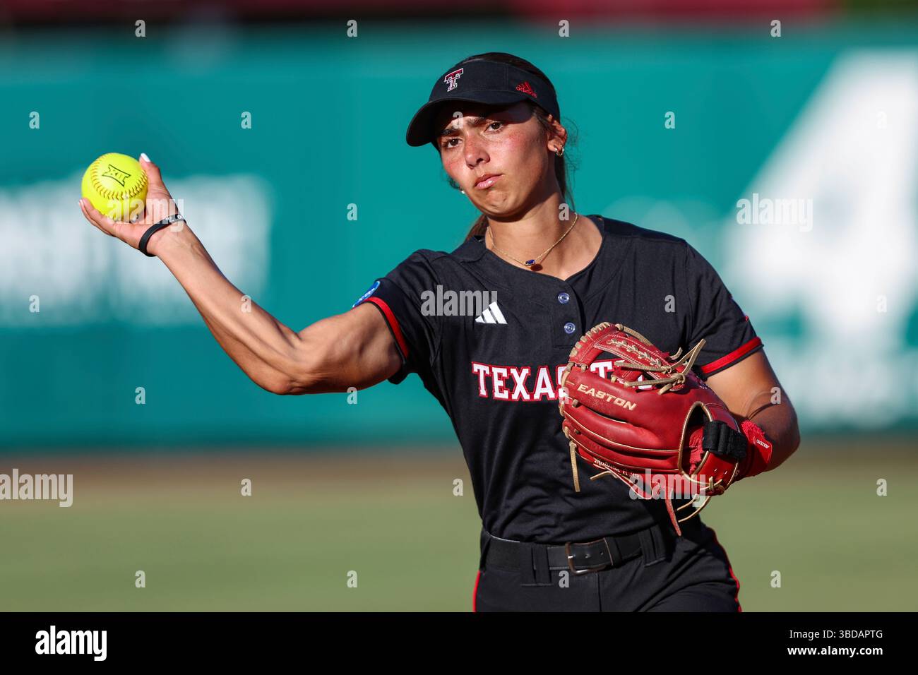 Texas Tech infielder Lauren Allred (11) warms up before an NCAA super ...
