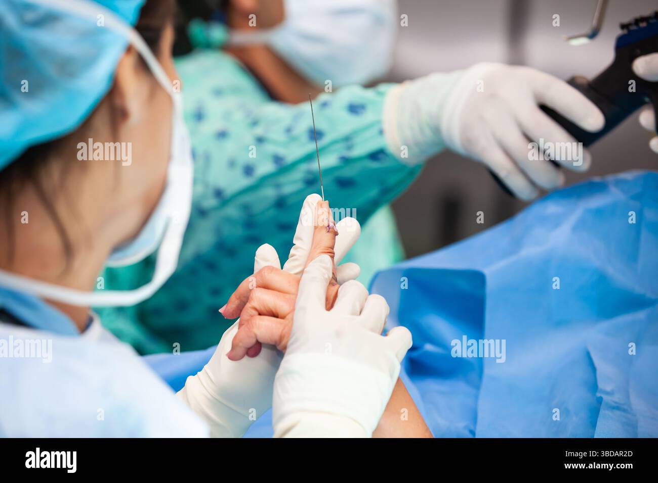 Female doctor performing a surgery. Orthopedic surgeon. Surgery and ...