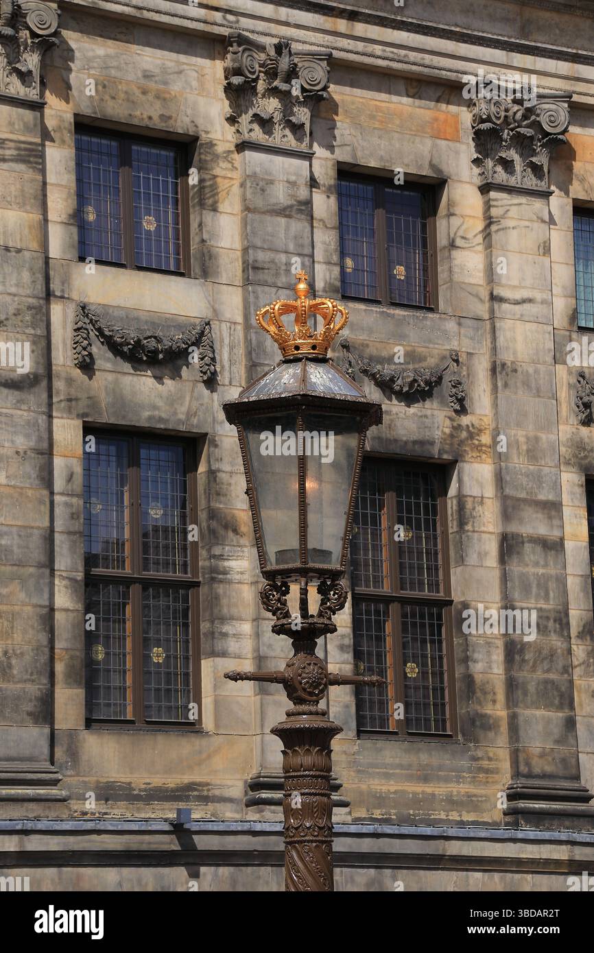 Royal Palace facade detail with historic lamp post with golden crown ...