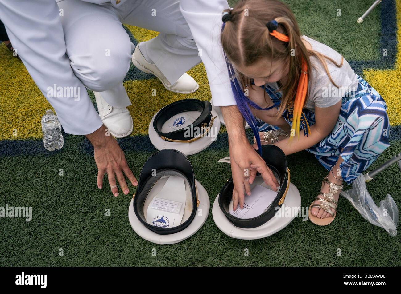 Annapolis, United States. 23rd May, 2025. Children collect hats ...