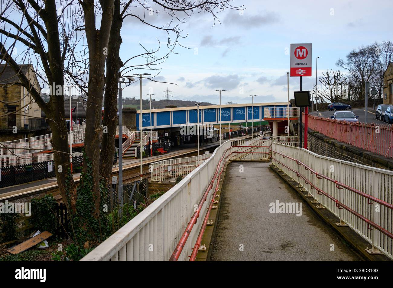 Urban railway scene featuring Brighouse Station, showcasing pedestrian ...