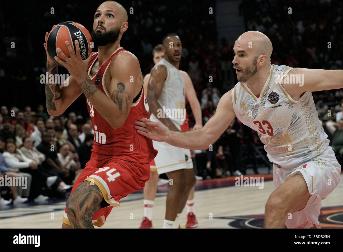 Olympiacos' Evan Fournier goes for a layup by Monaco's Nick Calathes ...