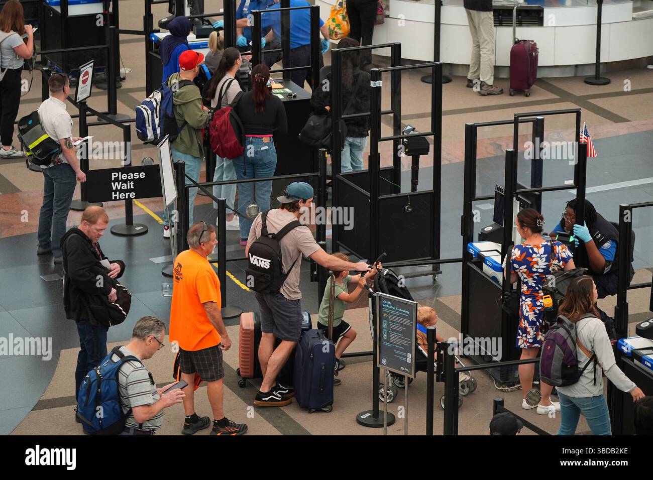 Travellers queue up at the south security checkpoint in Denver ...