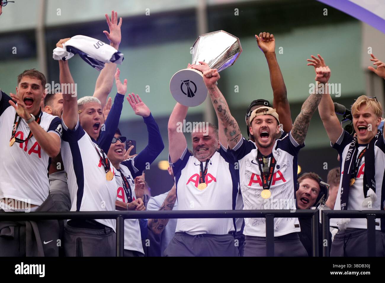 Tottenham Hotspur manager Ange Postecoglou with the trophy on stage ...