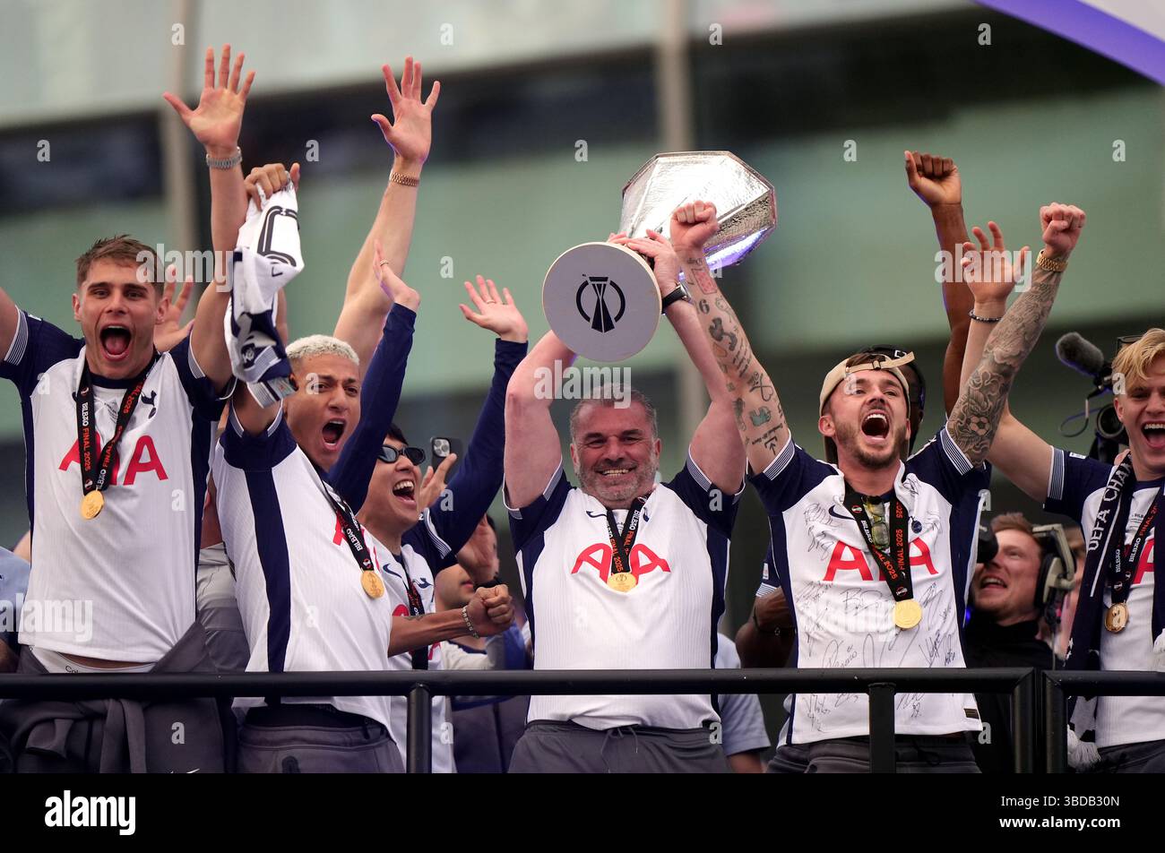 Tottenham Hotspur manager Ange Postecoglou with the trophy on stage ...