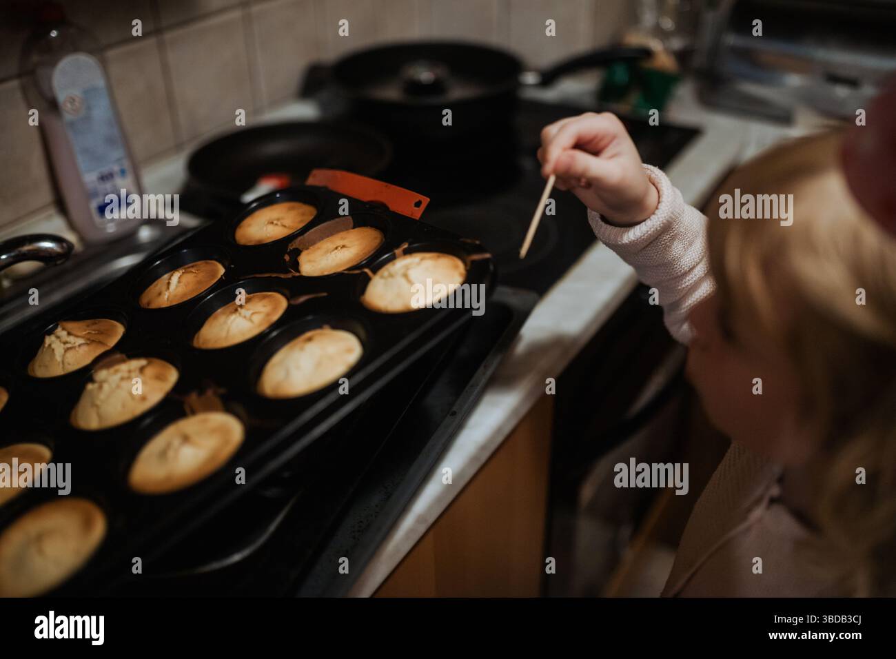 Children are happily engaged in baking sweet treats in the kitchen ...