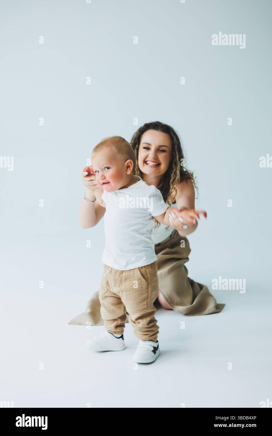 A nurturing mother encourages her toddlers first steps, capturing a ...