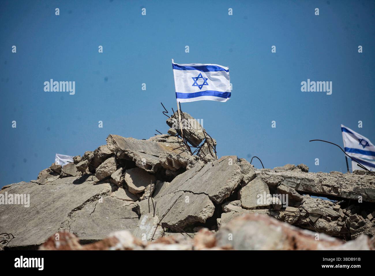 Jewish settlers raise Israeli flags on a Palestinian home destroyed by ...