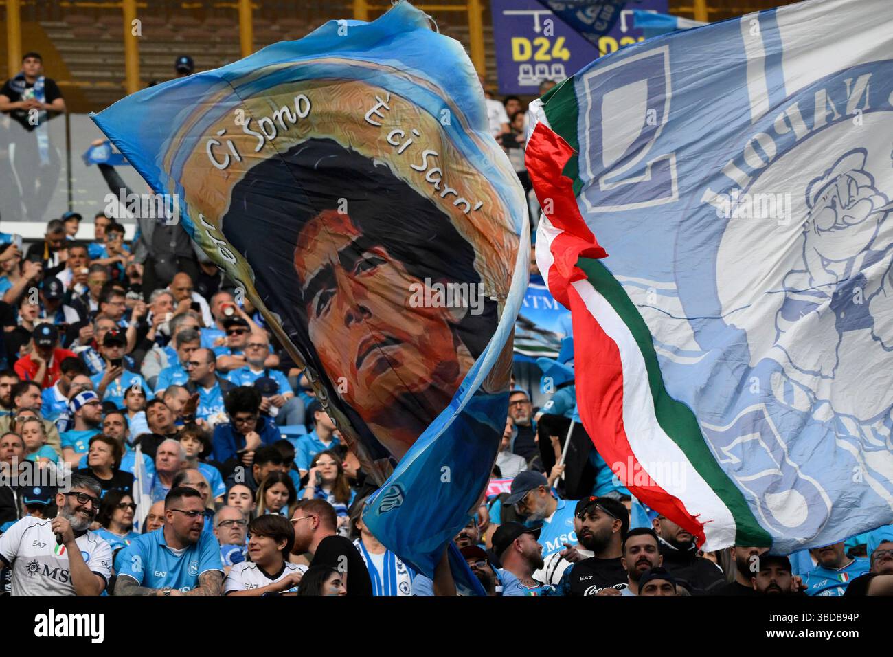 Napoli, Italy. 23rd May, 2025. Napoli fans wave a flag depicting Diego ...