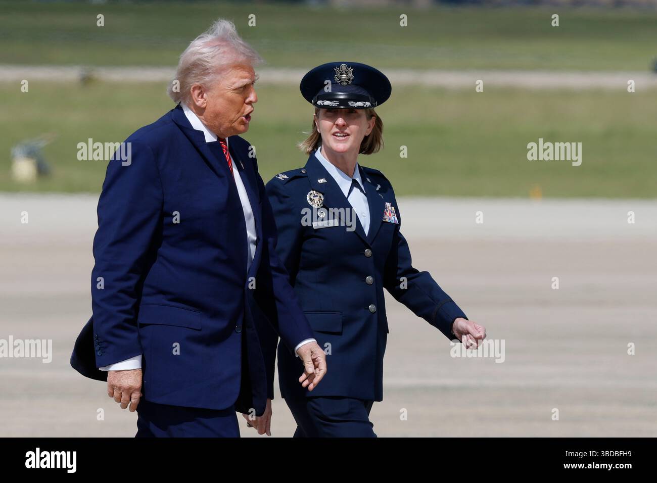President Donald Trump, left, is escorted by Air Force Col. Angela F ...
