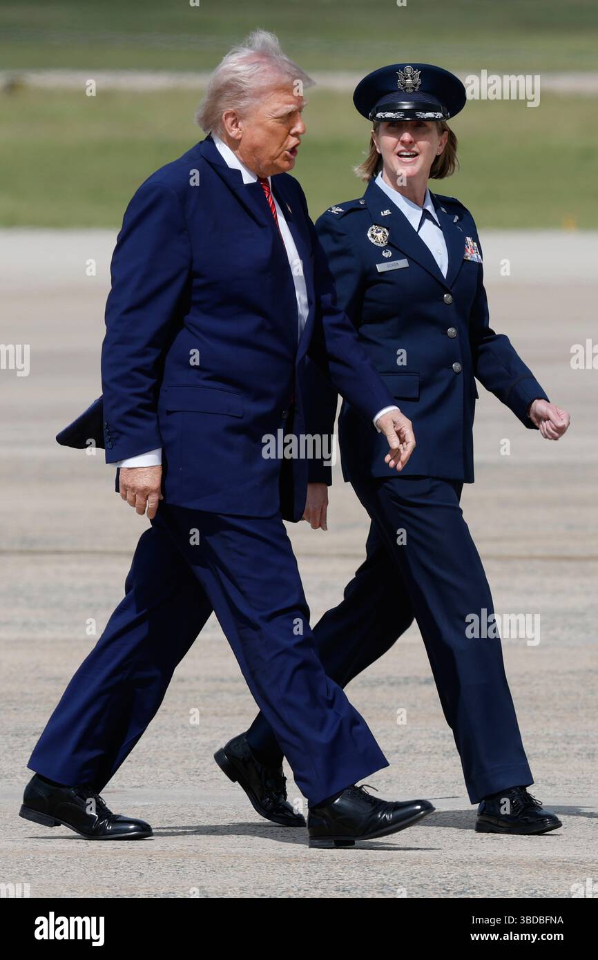President Donald Trump, left, is escorted by Air Force Col. Angela F ...