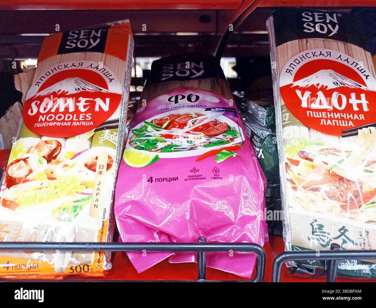 Assorted asian noodle packs on store shelf displaying somen, pho, and ...