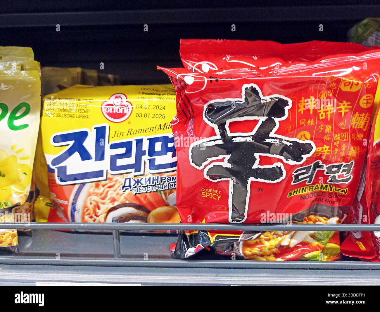 Assorted instant ramen packs on store shelf featuring korean brands ...