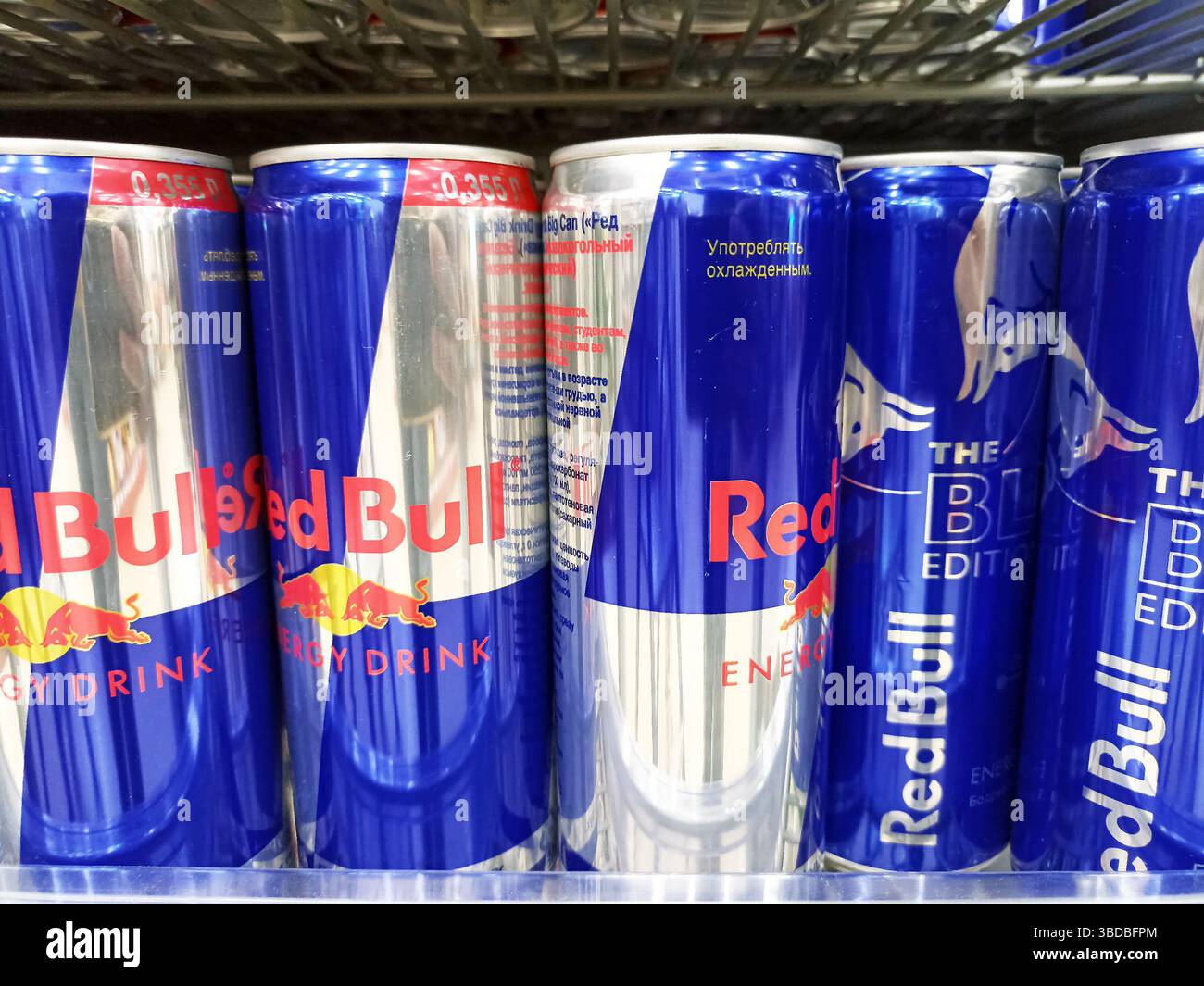 Assorted red bull energy drink cans on store shelf display Stock Photo ...