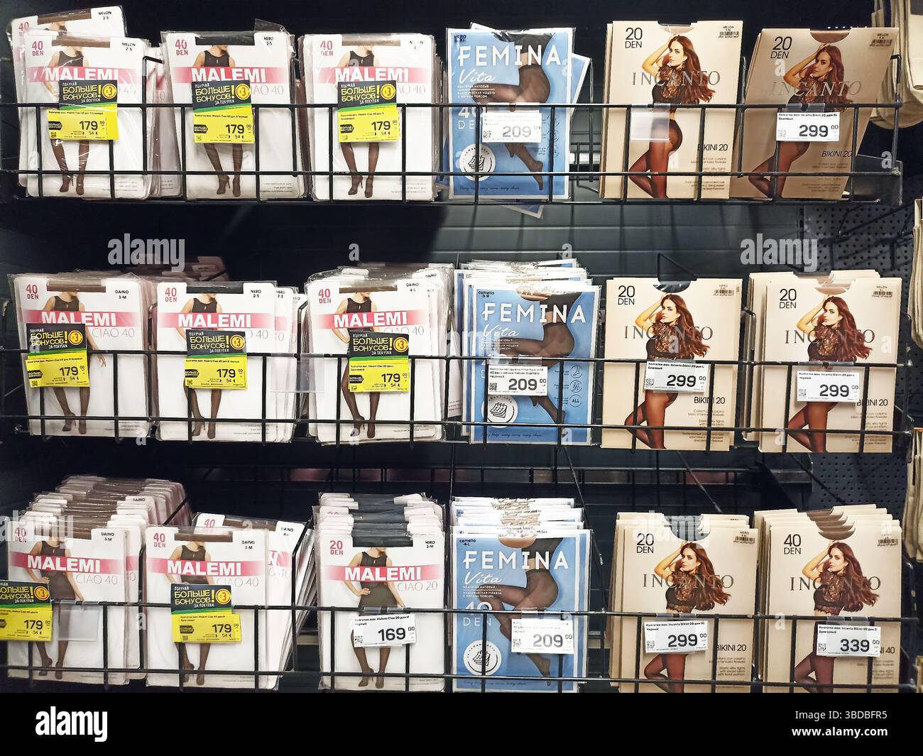 Assorted women's tights display on store shelf with various brands and ...