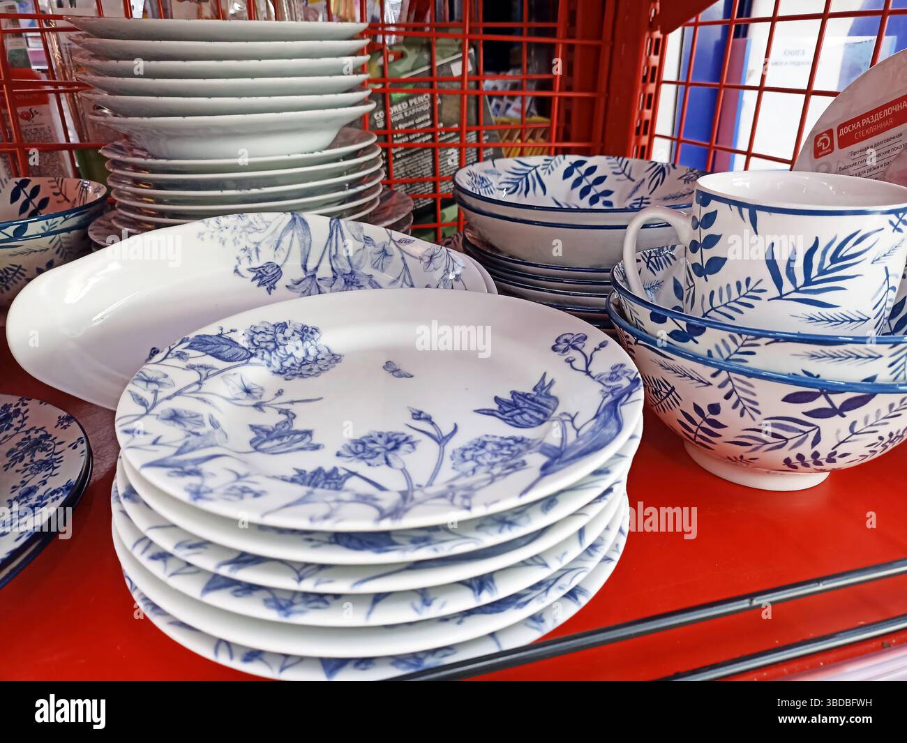 Blue floral dinnerware set with plates and cups on display shelf Stock ...