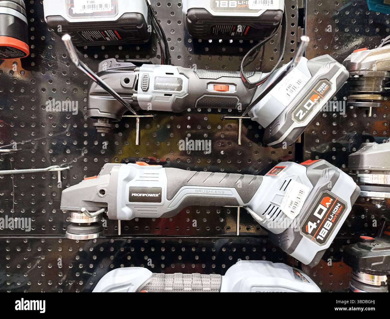 Cordless power tools display with batteries on pegboard wall Stock ...