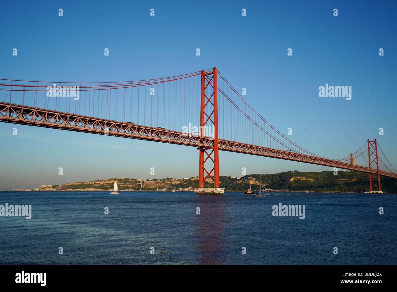 Lisbon, Portuagl, May 23rd 2025: A striking red suspension bridge, the ...