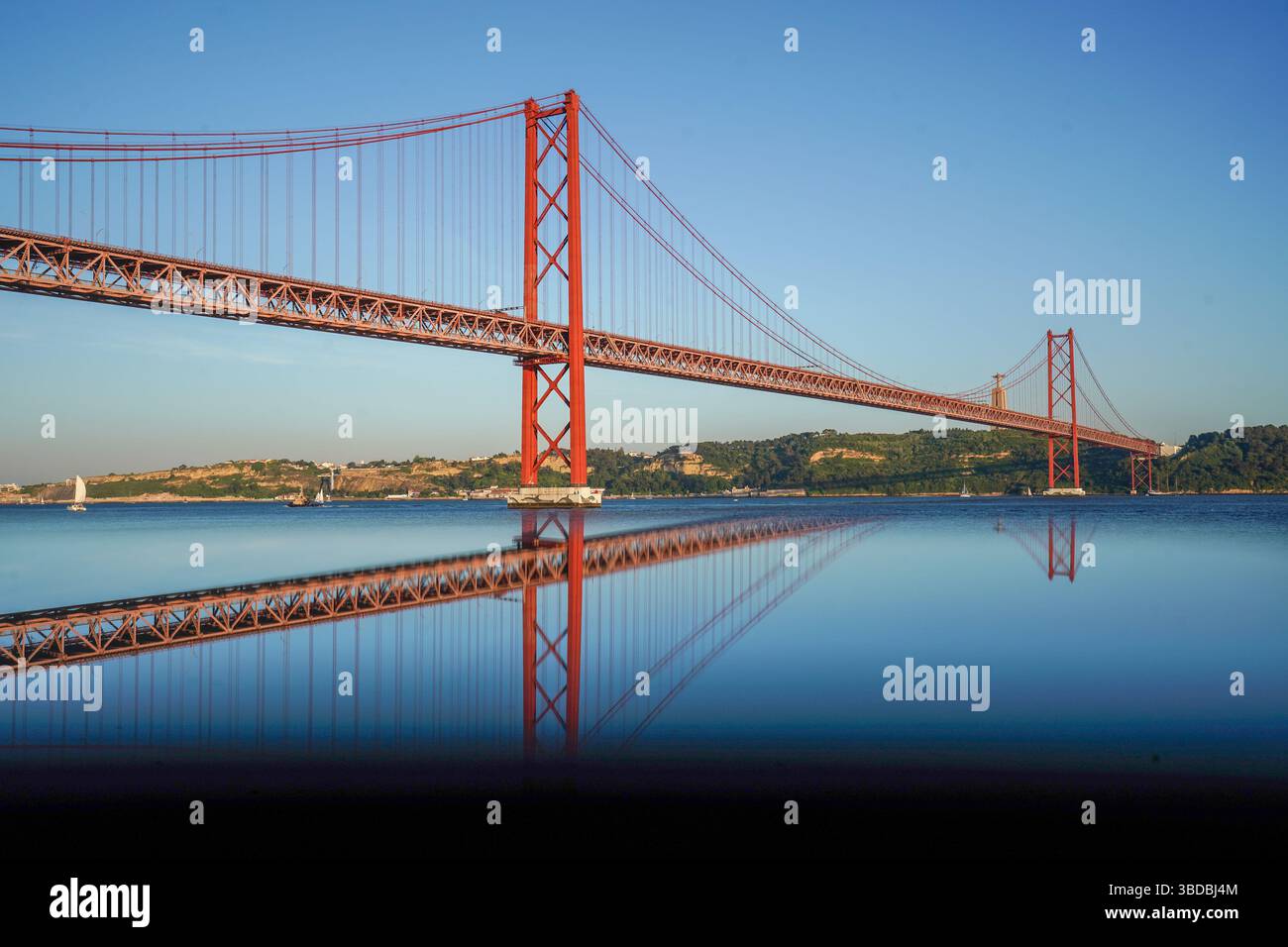 Lisbon, Portuagl, May 23rd 2025: A striking red suspension bridge, the ...