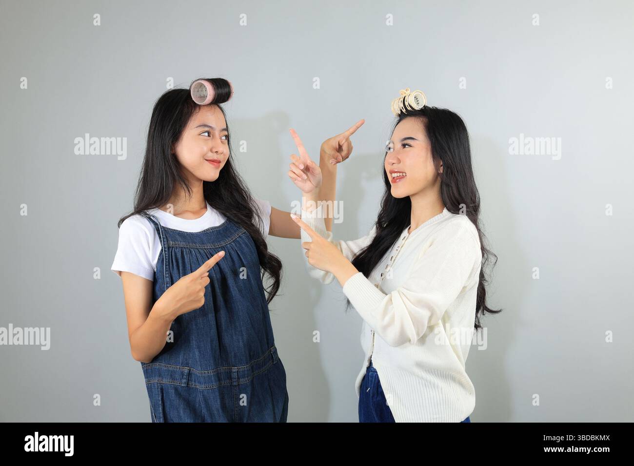 Two Young Asian Female Friend Smiling Pointing at Each Other Hair ...