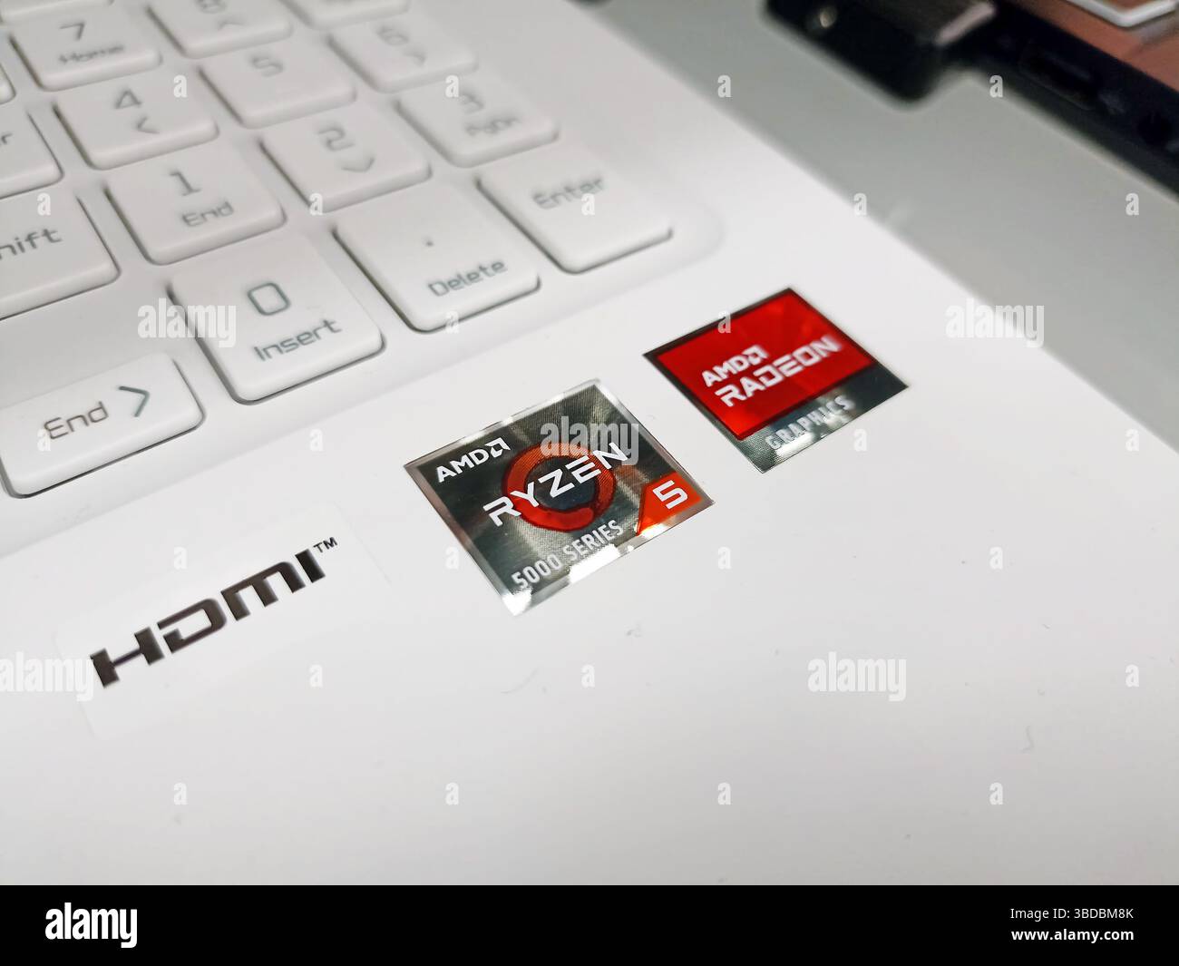 White laptop with amd ryzen 5 and radeon graphics stickers, hdmi logo ...