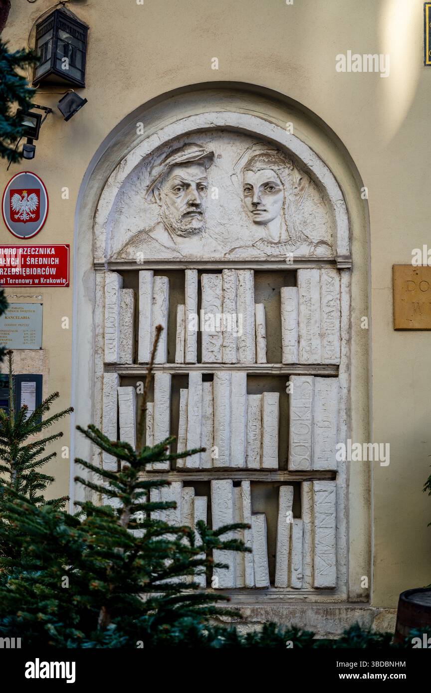 Stone Book Relief and Historical Figures on Building Wall in Kraków ...