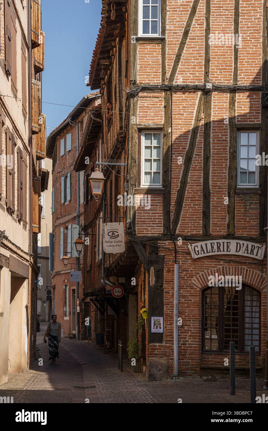 Narrow medieval houses line this old town street in Albi France with ...