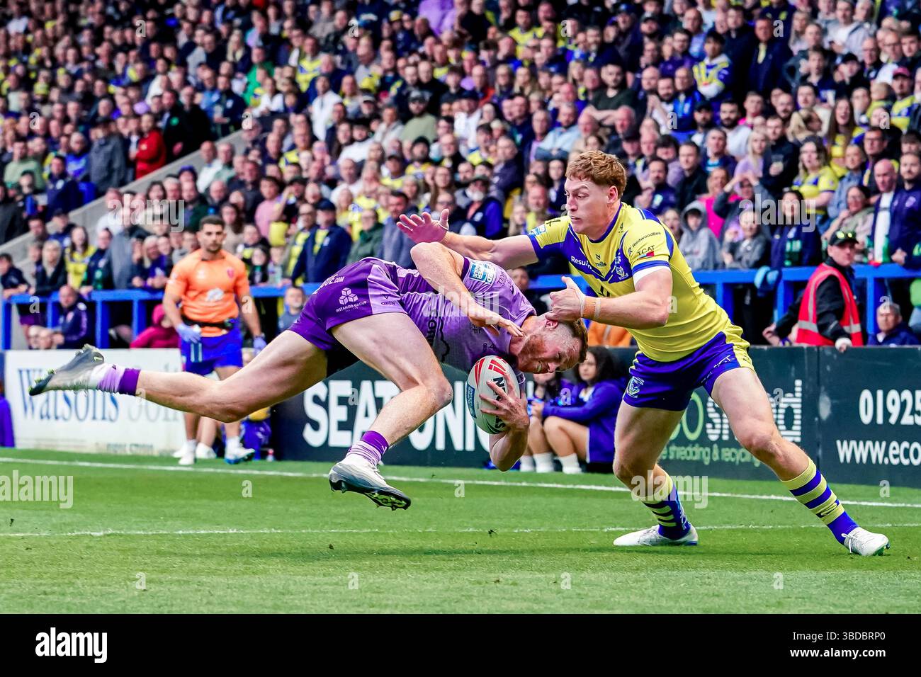 WARRINGTON, ENGLAND - MAY 23: Joe Burgress is tackled by Dan Russell ...