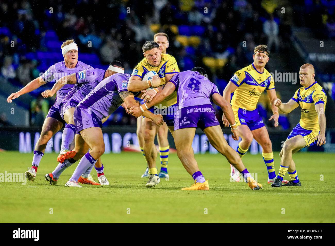 WARRINGTON, ENGLAND - MAY 23: Luke Yates is stopped by three Hull KR ...