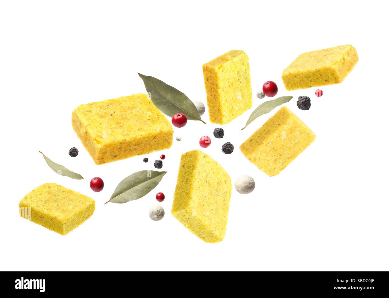 Bouillon cubes and spices flying on white background Stock Photo - Alamy