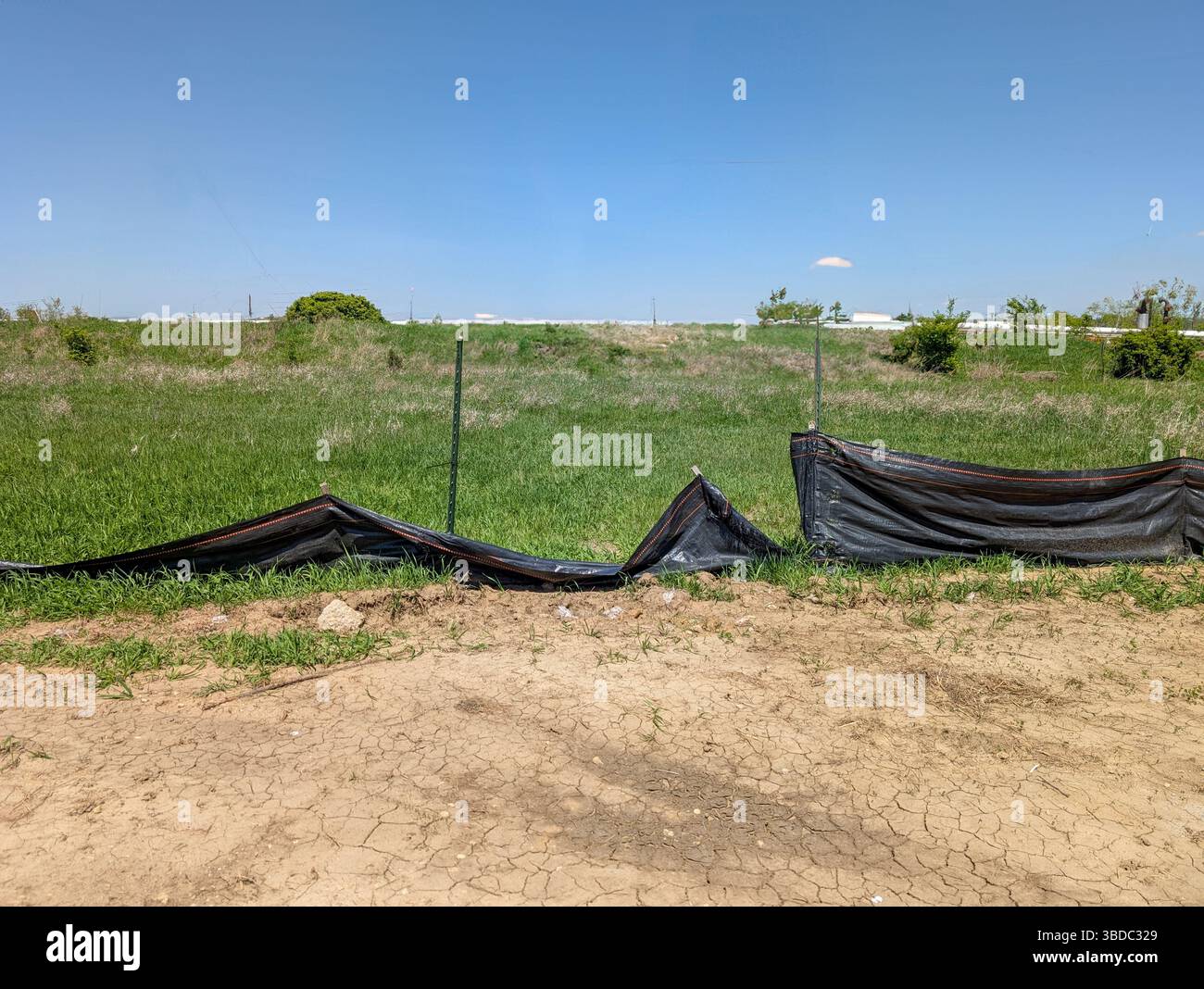 Sagging and damaged stormwater fabric silt fence at a construction site ...