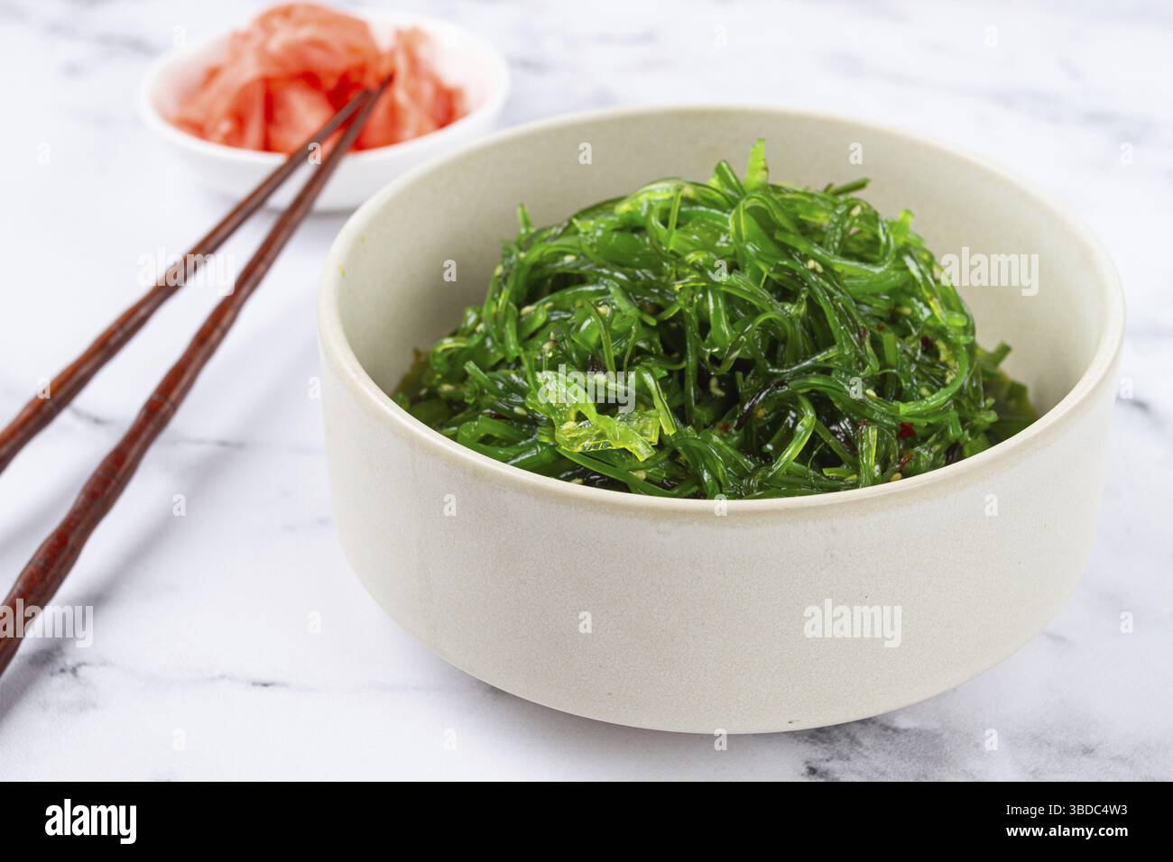 Chuka salad, made from fresh seaweed, with sesame dressing, in a white ...