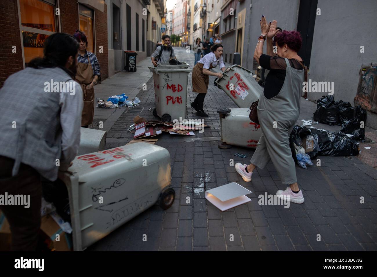 Madrid, Spain. 23rd May, 2025. Protesters drag garbage cans from a ...