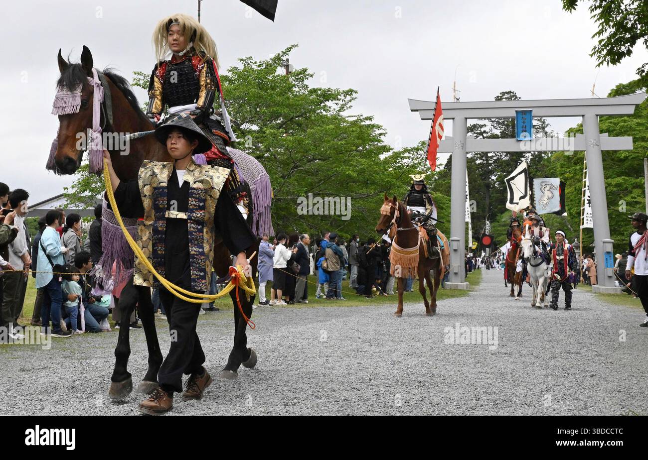 Samurai horseback riders clad in armor march along the front approach ...